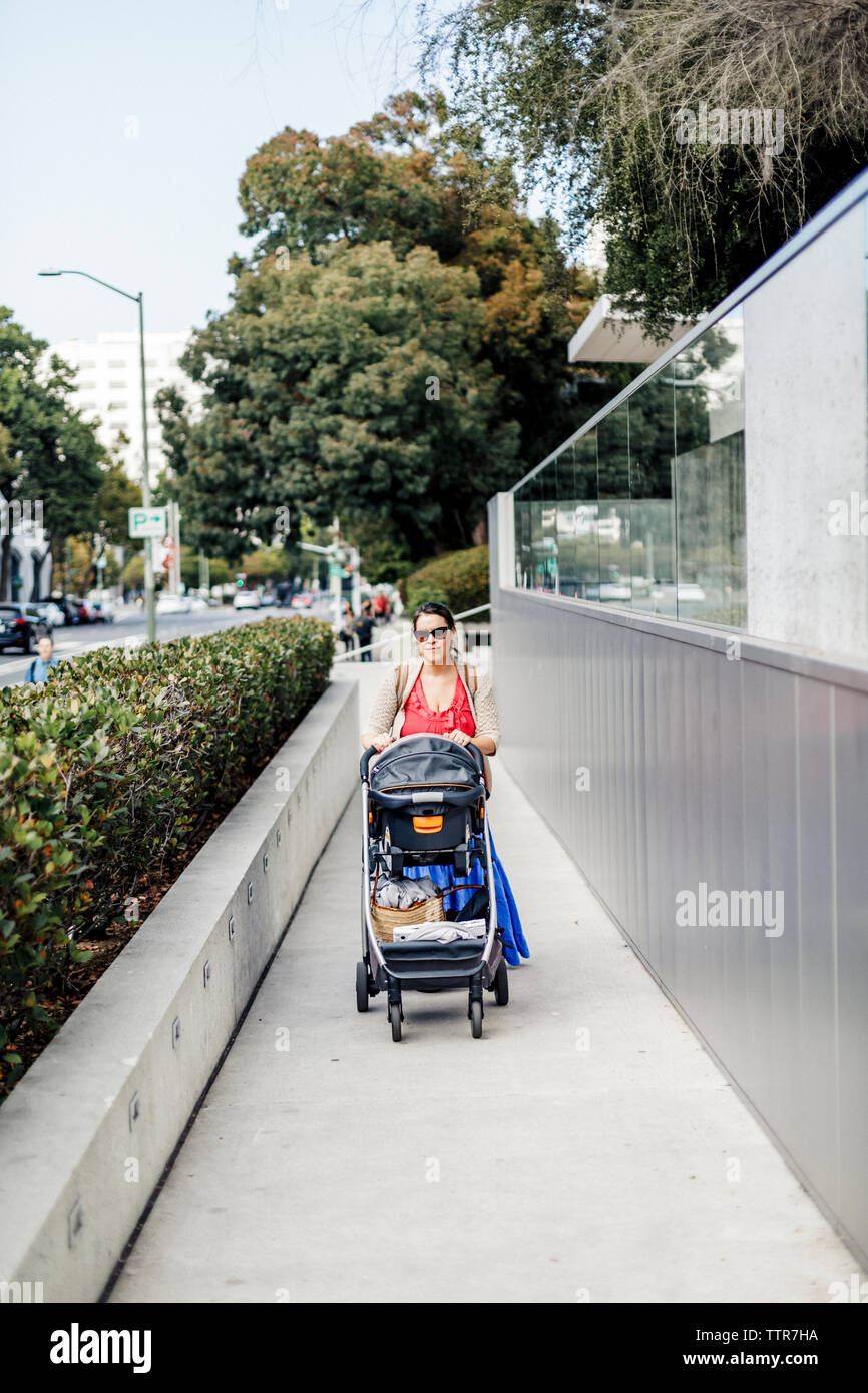 Woman pushing baby stroller hi-res stock photography and images - Alamy