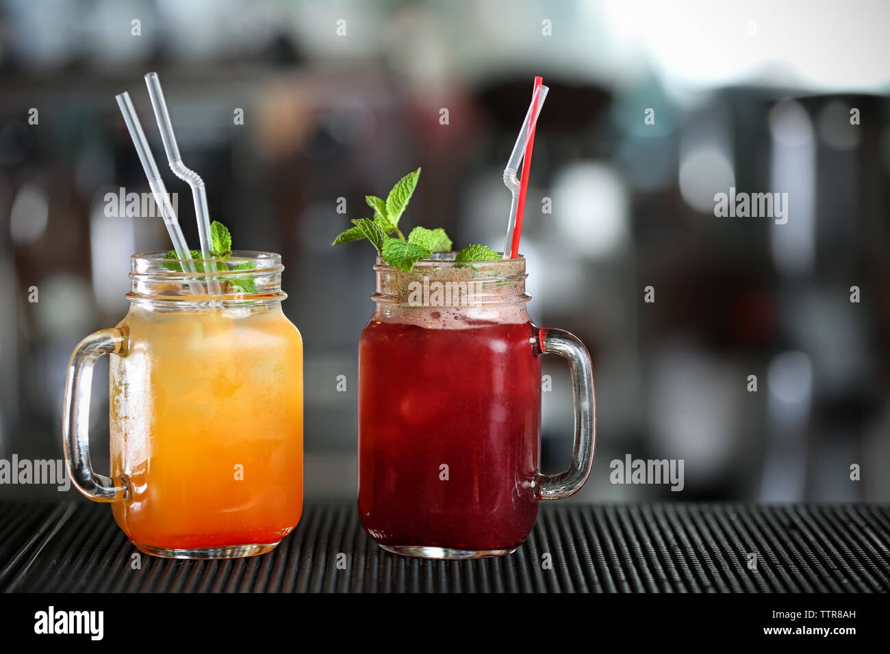 Different cocktails in glass jars on bar counter Stock Photo - Alamy