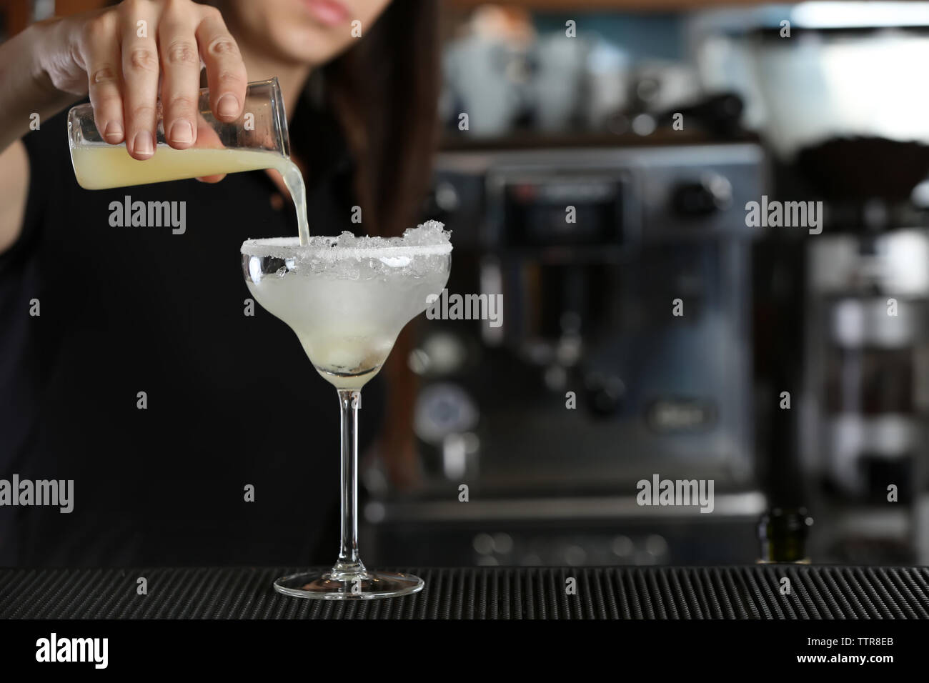 Woman hands making cocktail on bar counter Stock Photo - Alamy