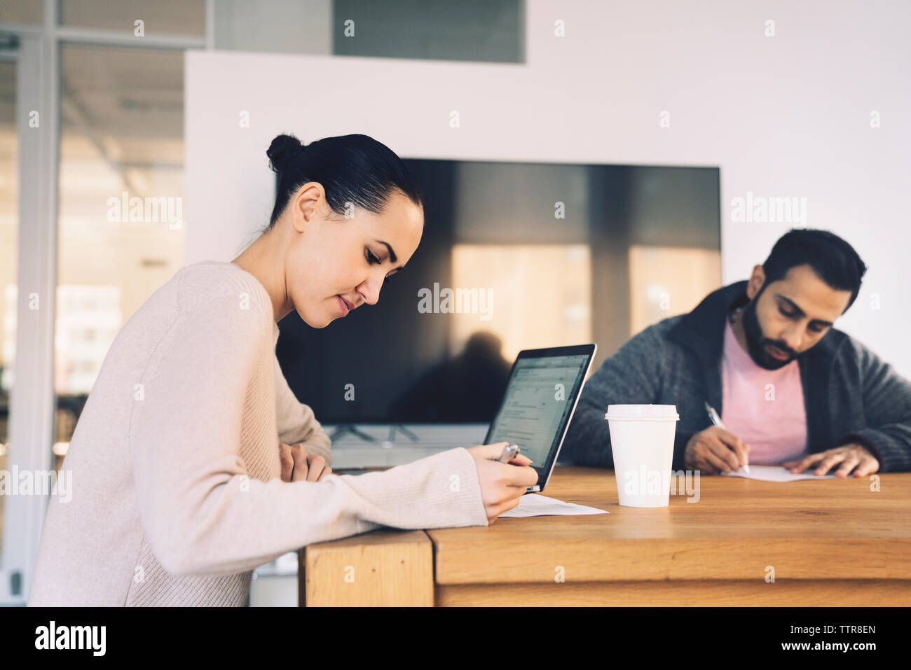 Man writing desk in front of computer hi-res stock photography and ...