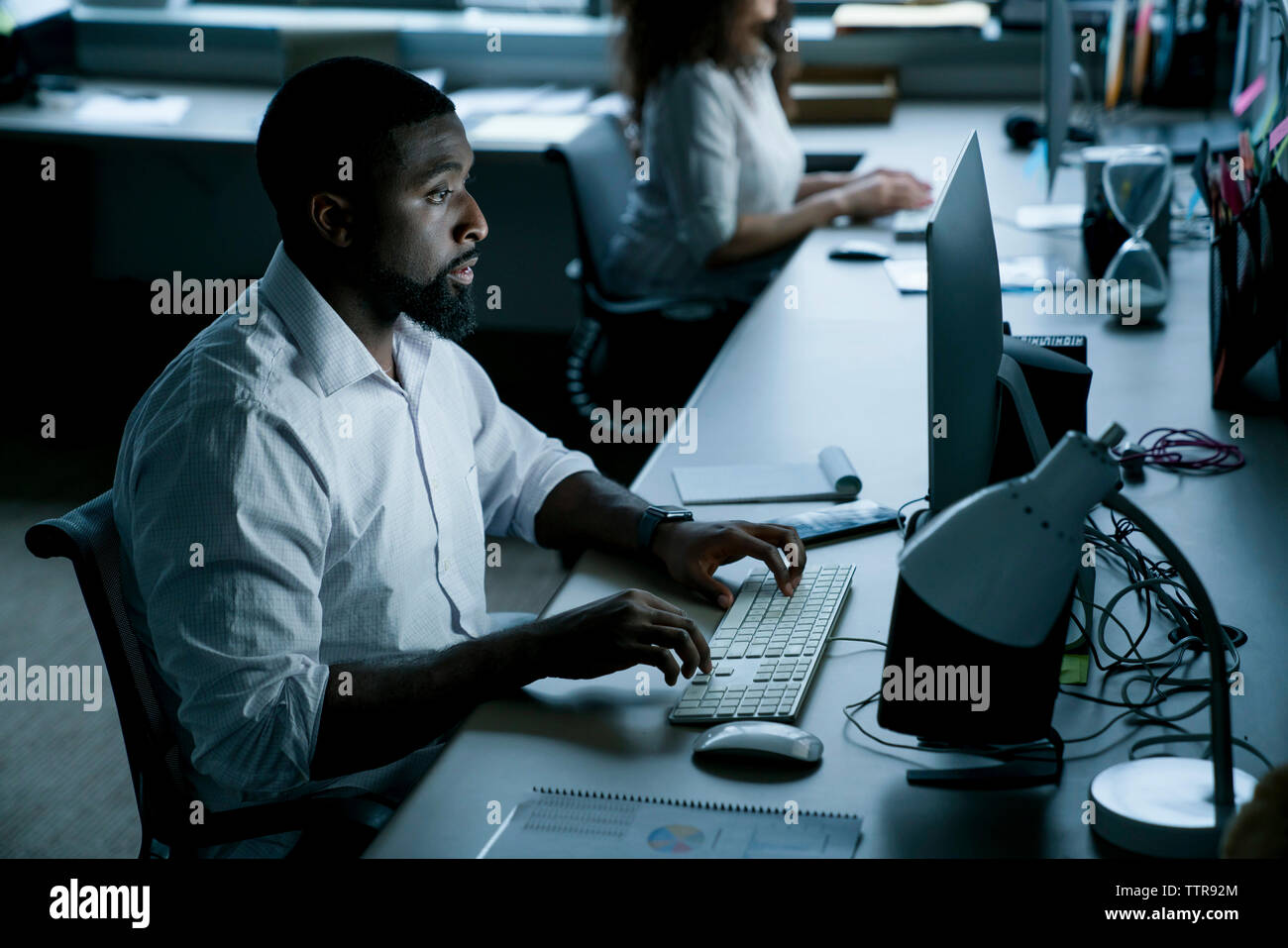 business people working on desktop computers at desk in office Stock ...