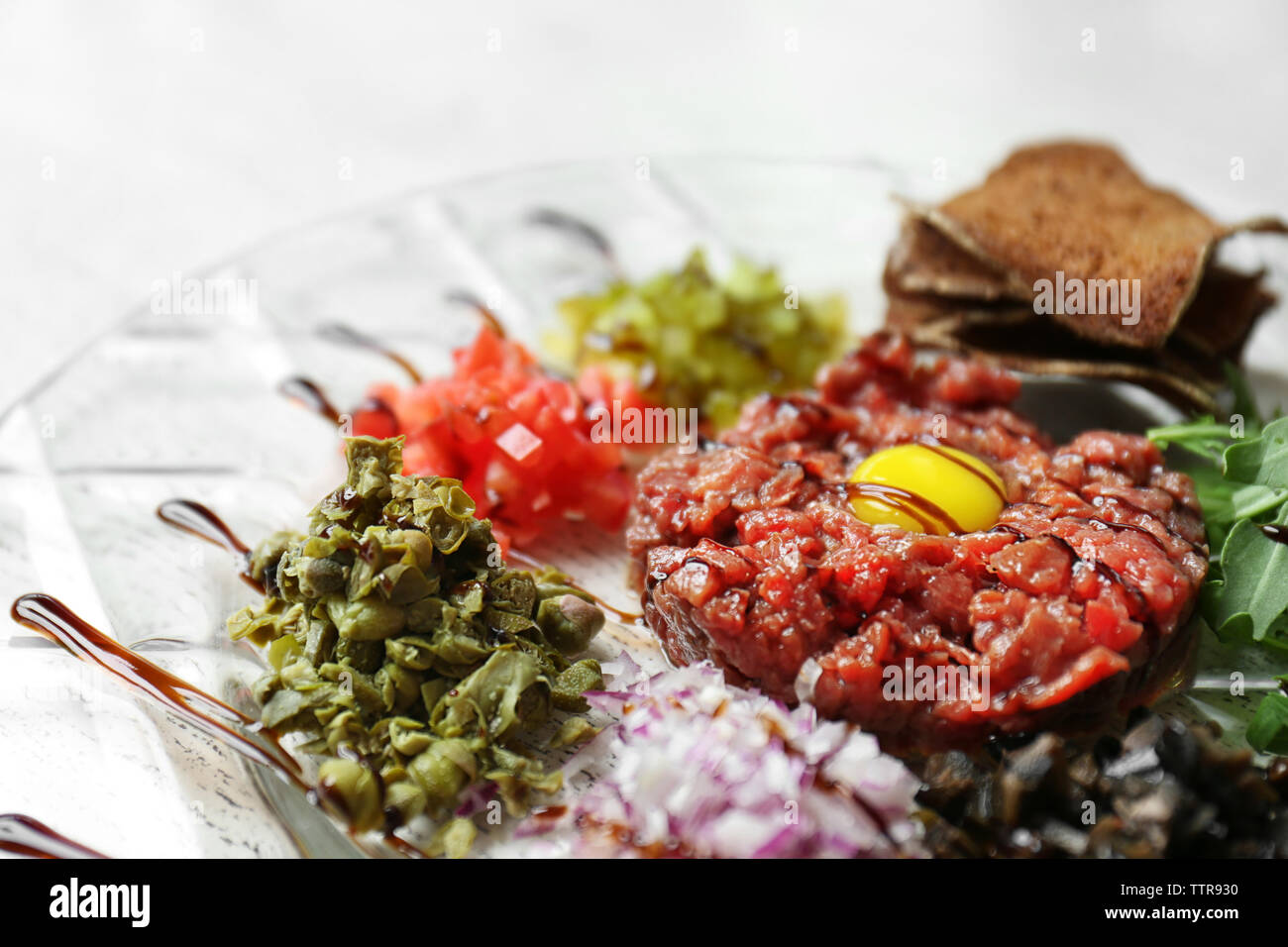 Plate with diced meat and different snacks Stock Photo - Alamy