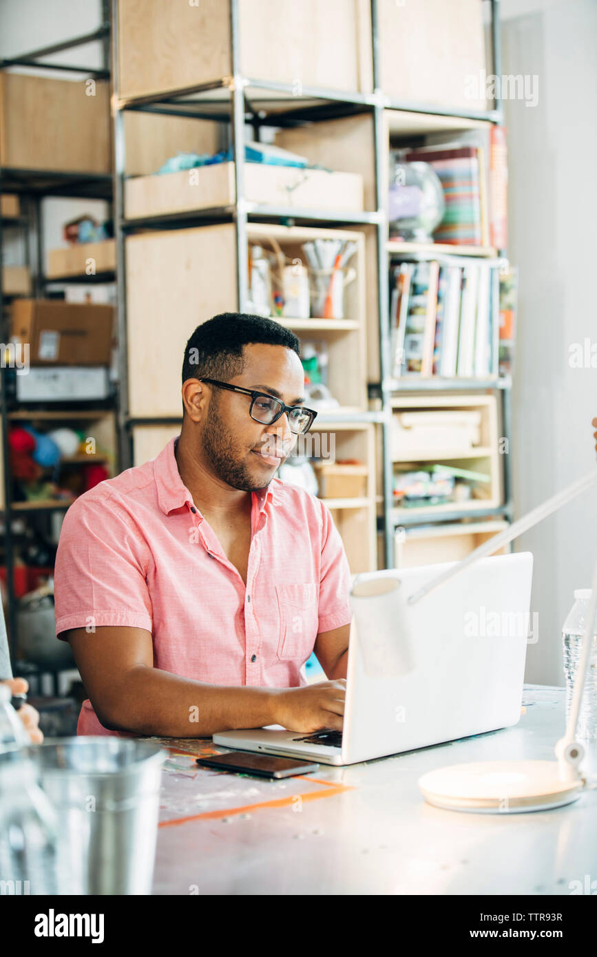 Smart african man on computer in office hi-res stock photography and ...