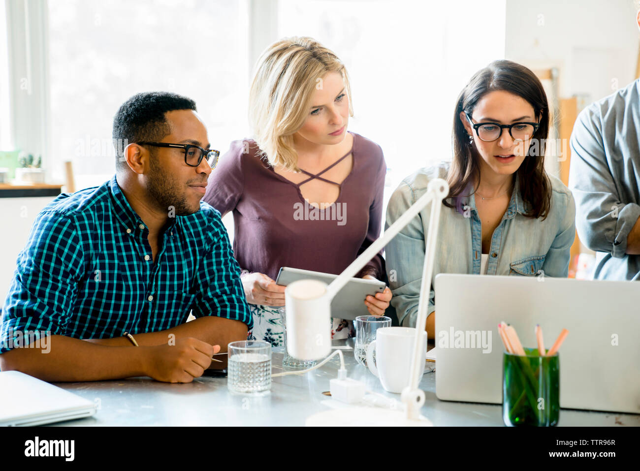 business people looking at laptop computer during meeting Stock Photo ...