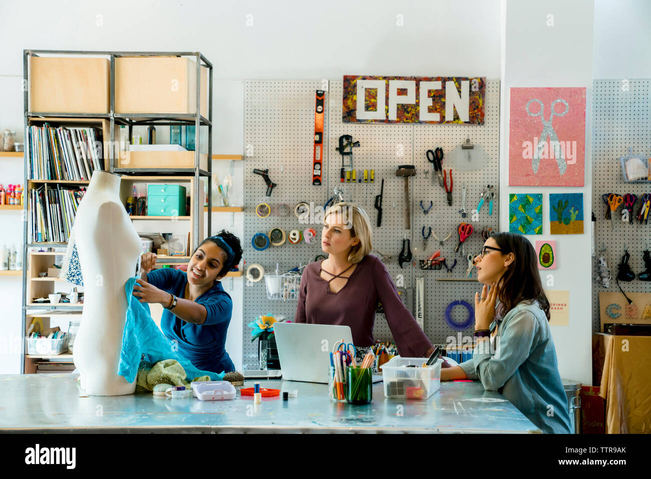 Fashion designers working on mannequin in creative office Stock Photo ...