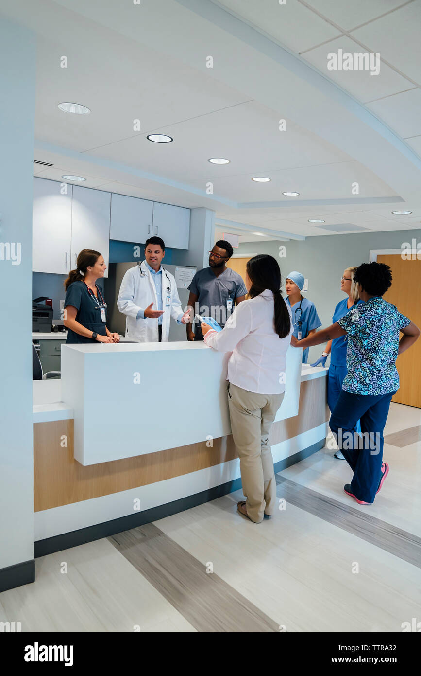 Doctors discussing during meeting at hospital reception Stock Photo - Alamy Doctors discussing during meeting at hospital reception Stock Photo - Alamy
