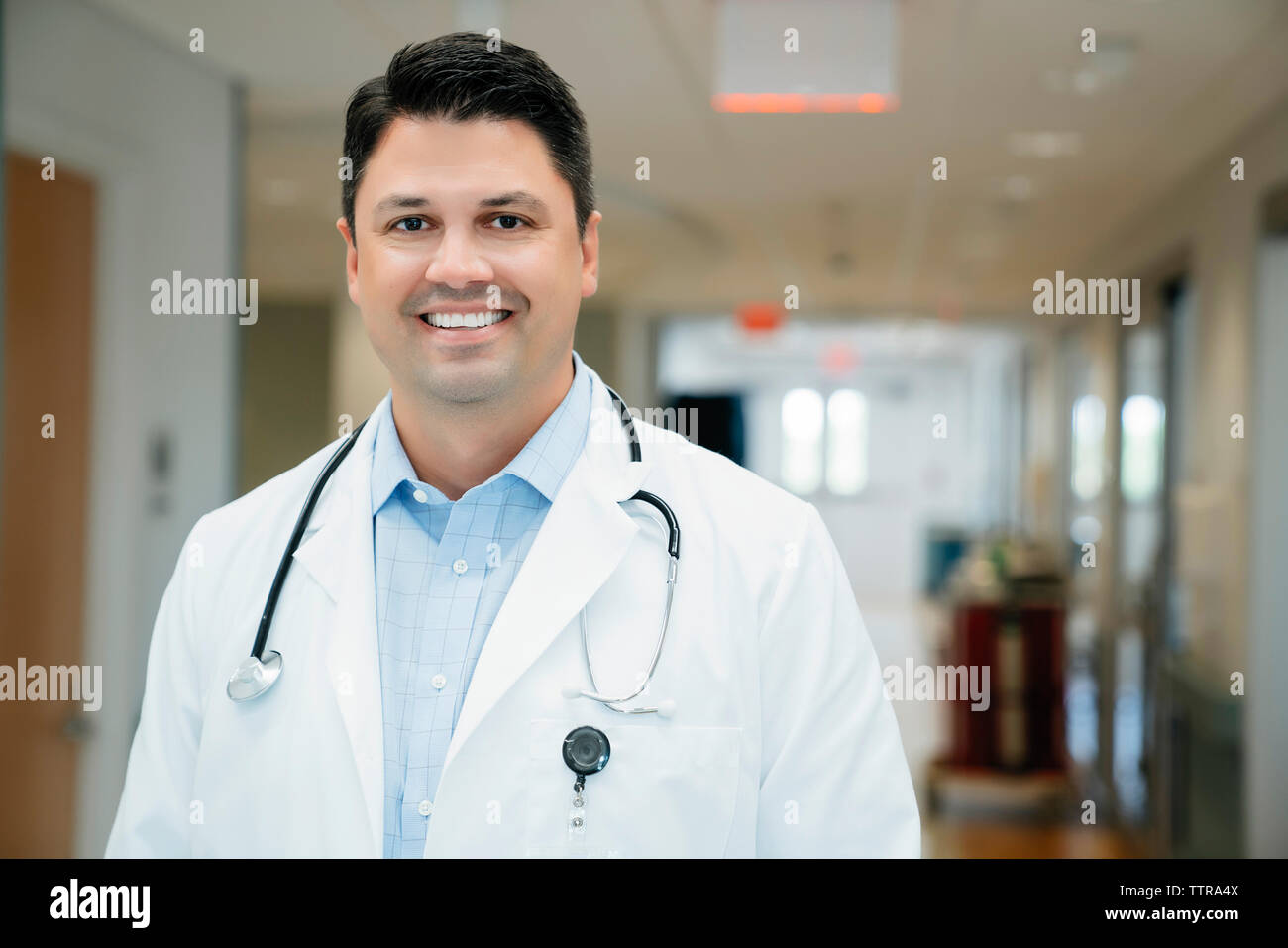 Doctor standing in hospital corridor hi-res stock photography and ...