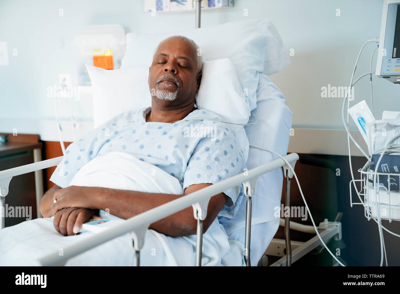 Senior patient sleeping on bed in hospital ward Stock Photo - Alamy