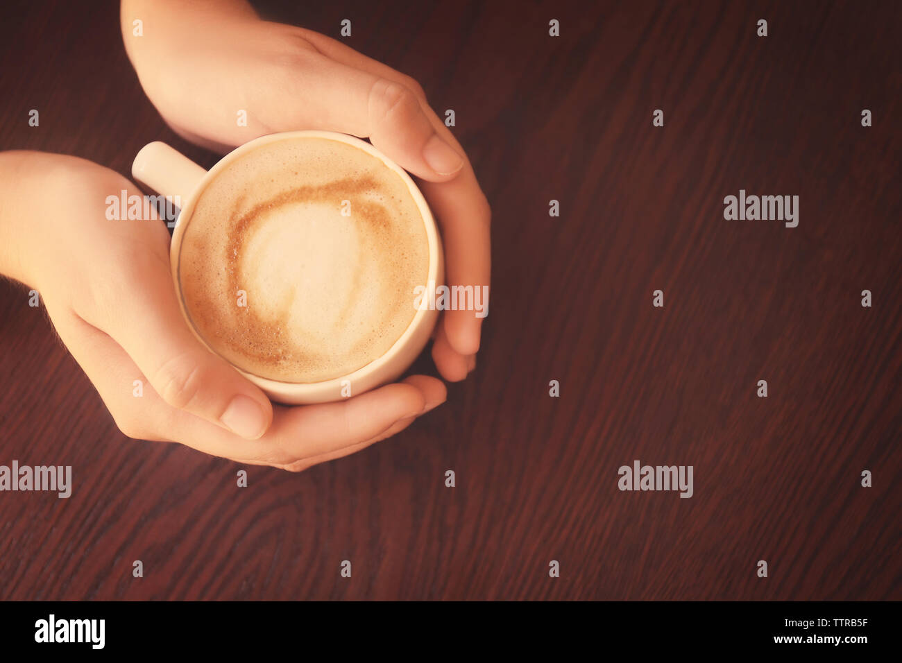 Female hands holding cup of coffee in cafe Stock Photo - Alamy