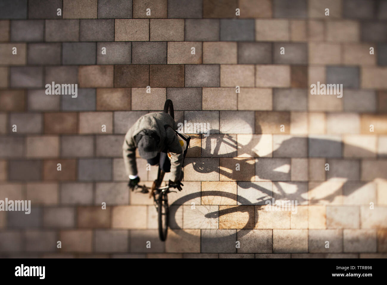 Overhead view of man riding bicycle on street Stock Photo - Alamy