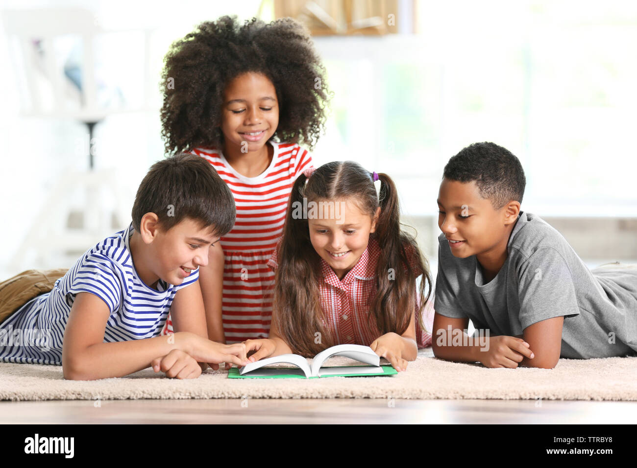 Cute kids reading book at home Stock Photo - Alamy