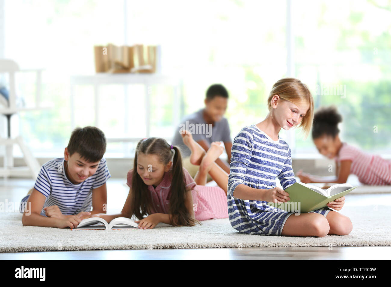 Cute kids reading books at home Stock Photo - Alamy