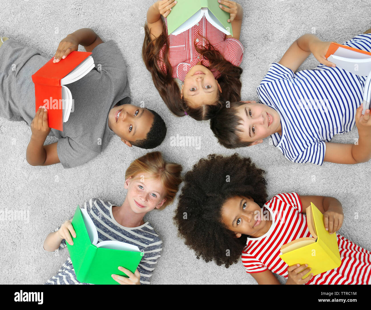 Cute kids reading books at home Stock Photo - Alamy