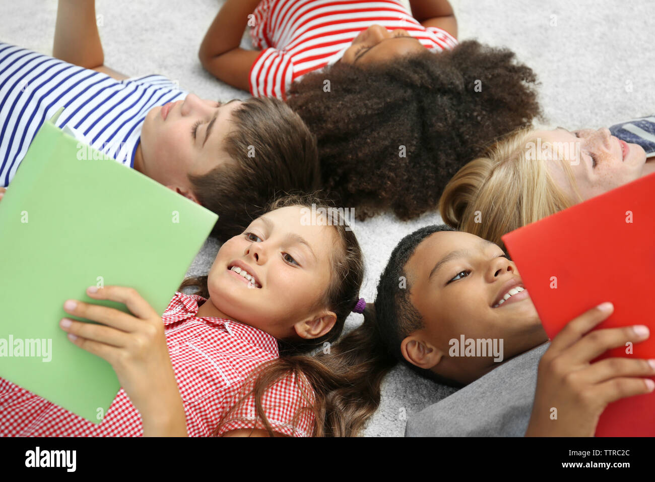 Cute kids reading books at home Stock Photo - Alamy