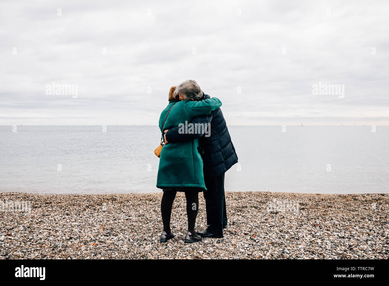 Rear view of senior couple hugging next to the beach Stock Photo - Alamy