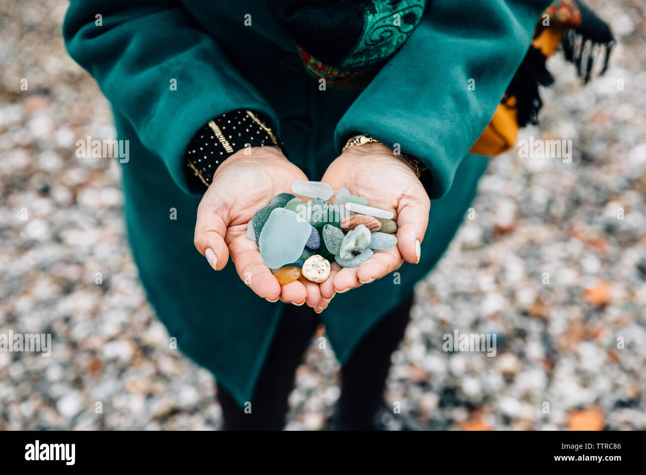 Detail of a woman showing some stones in her hands Stock Photo - Alamy