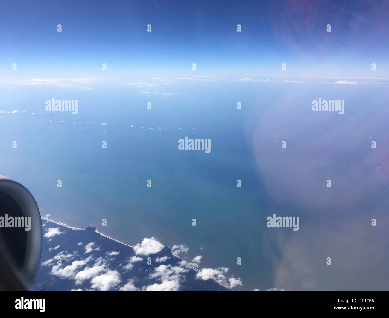 Scenic view of seascape seen through airplane window Stock Photo - Alamy