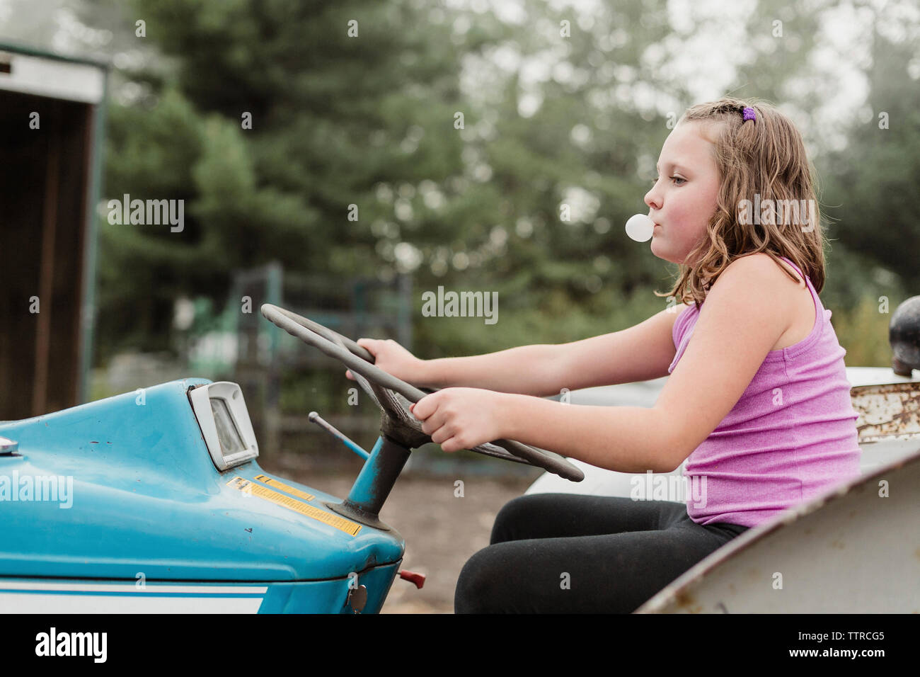 Girl driving tractor hi-res stock photography and images - Alamy