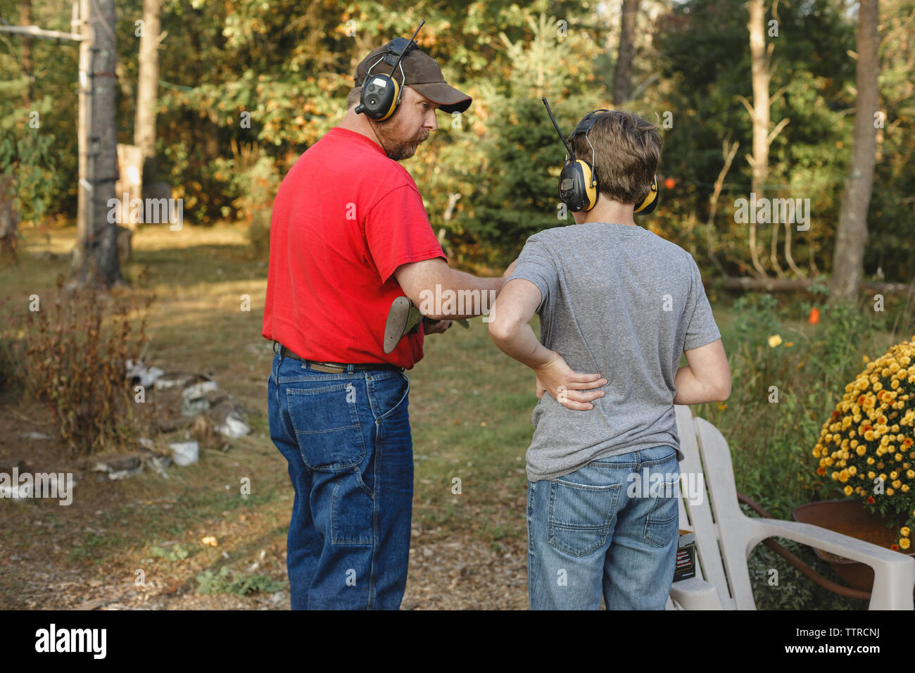 Father teaching son with rifle hi-res stock photography and images - Alamy