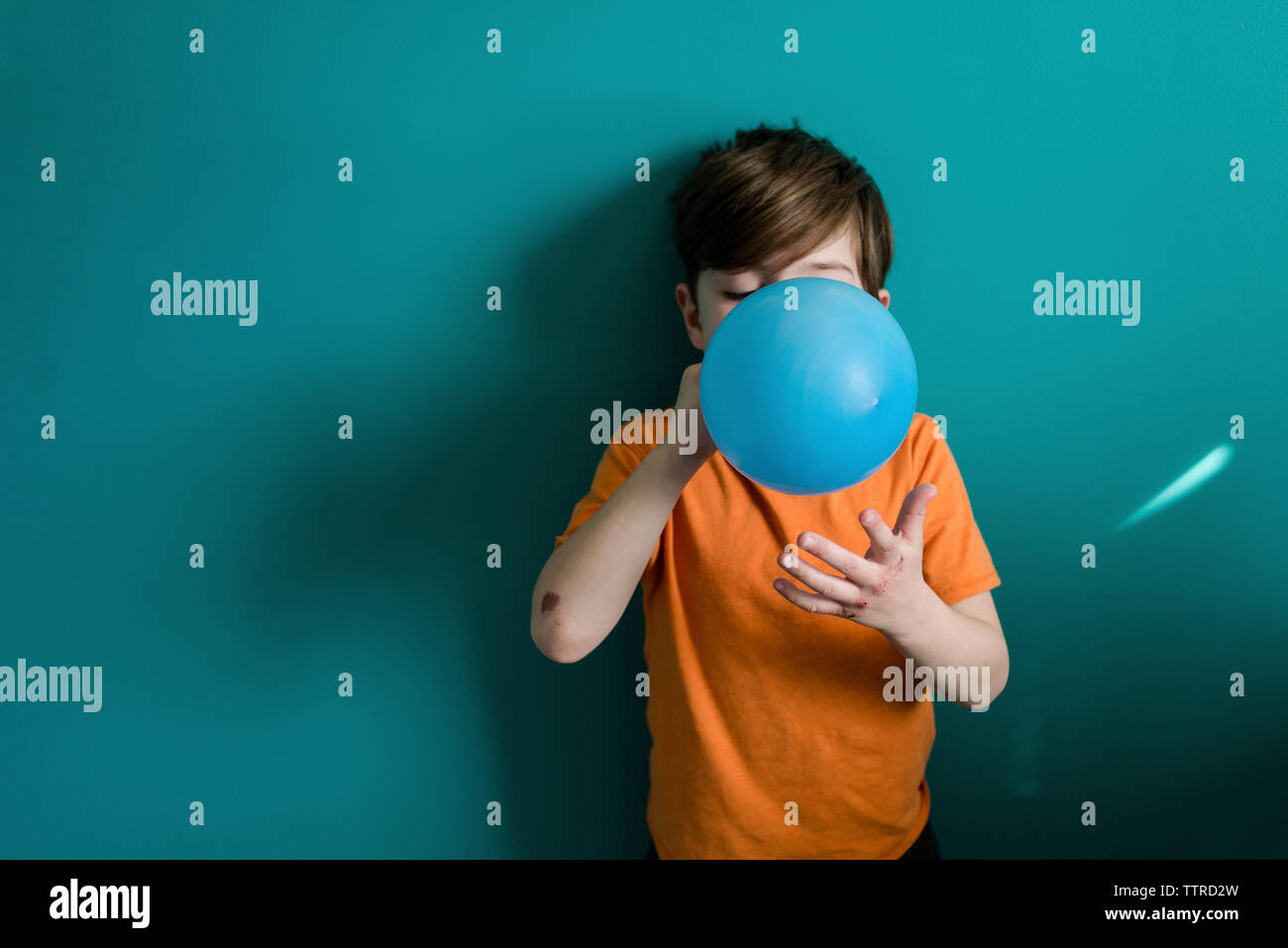 Boy blowing up balloon hi-res stock photography and images - Alamy