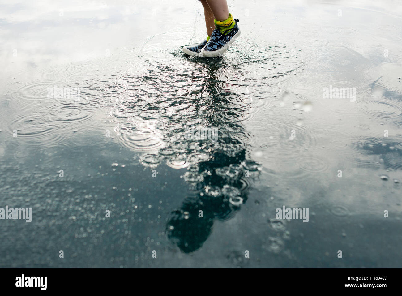Boy puddle splashing hi-res stock photography and images - Alamy