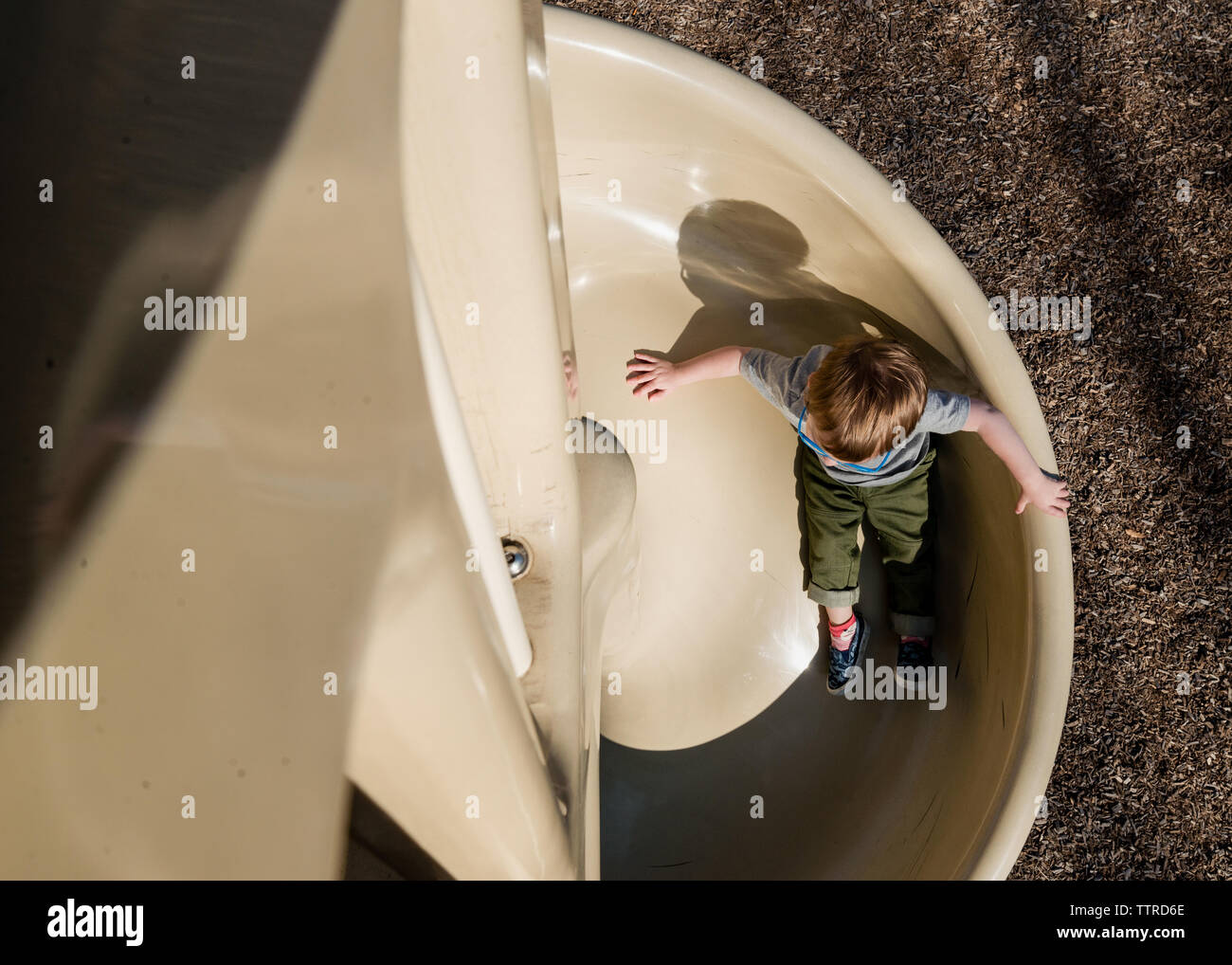 Boy on slide playing hi-res stock photography and images - Alamy