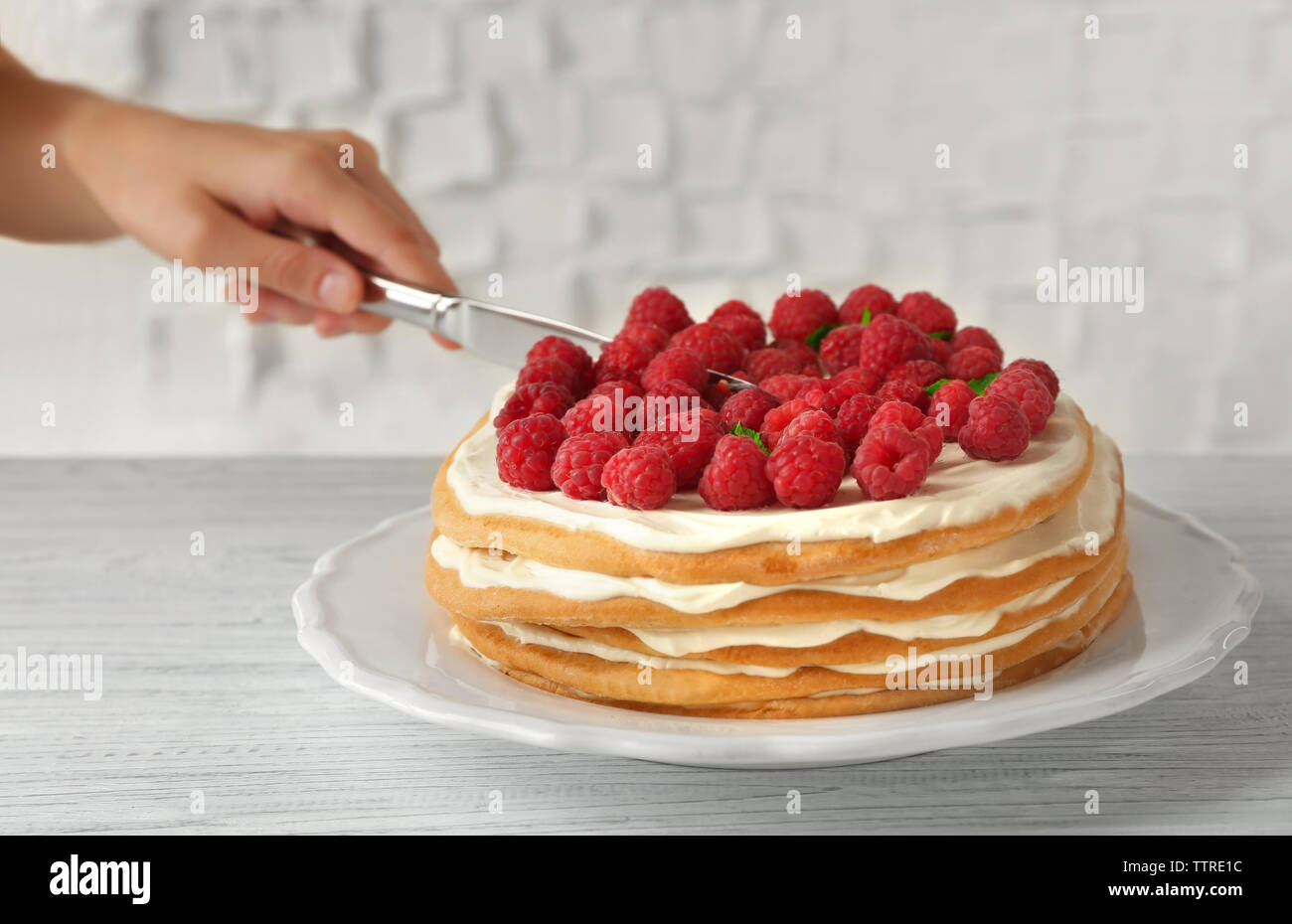 Hand cutting a birthday cake with decoration cake hi-res stock ...