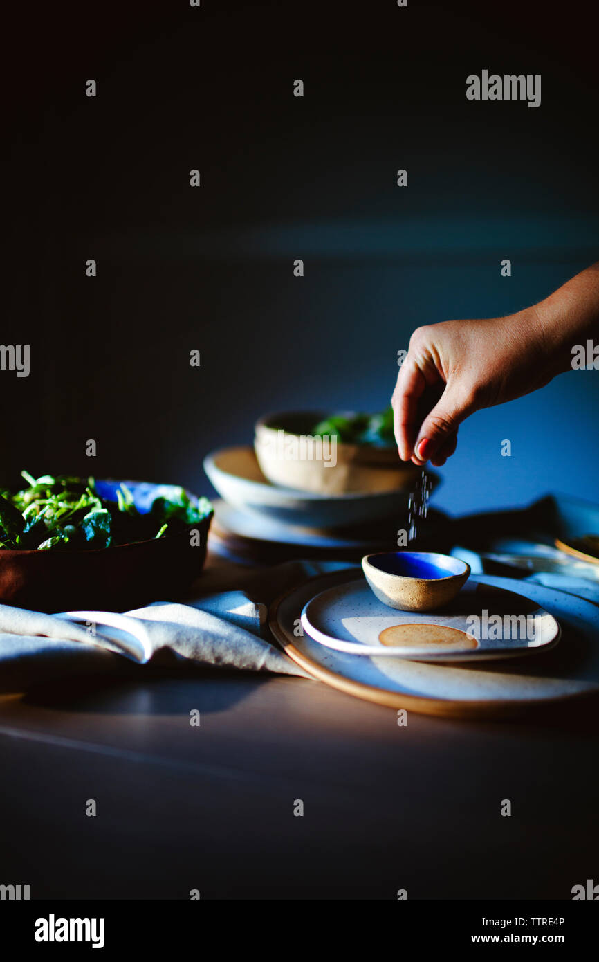 Female hand sprinkling salt hi-res stock photography and images - Alamy