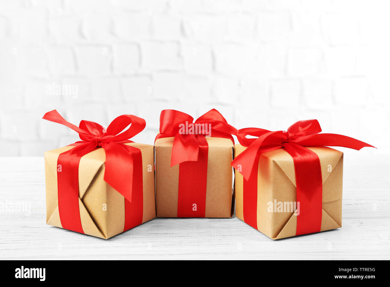 Gift boxes on brick wall background Stock Photo - Alamy