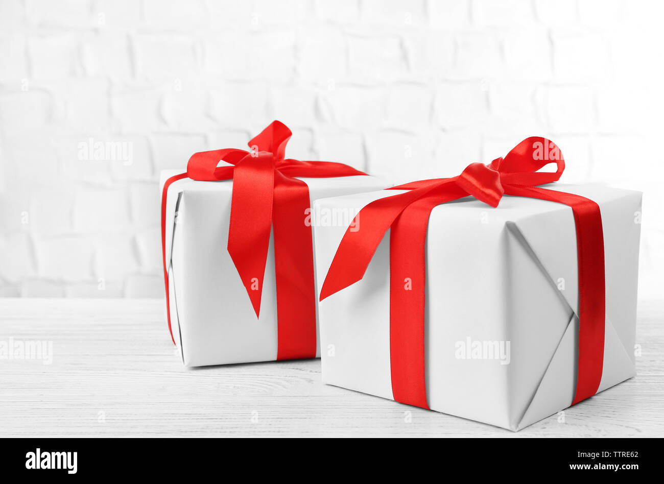 Gift boxes on brick wall background Stock Photo - Alamy