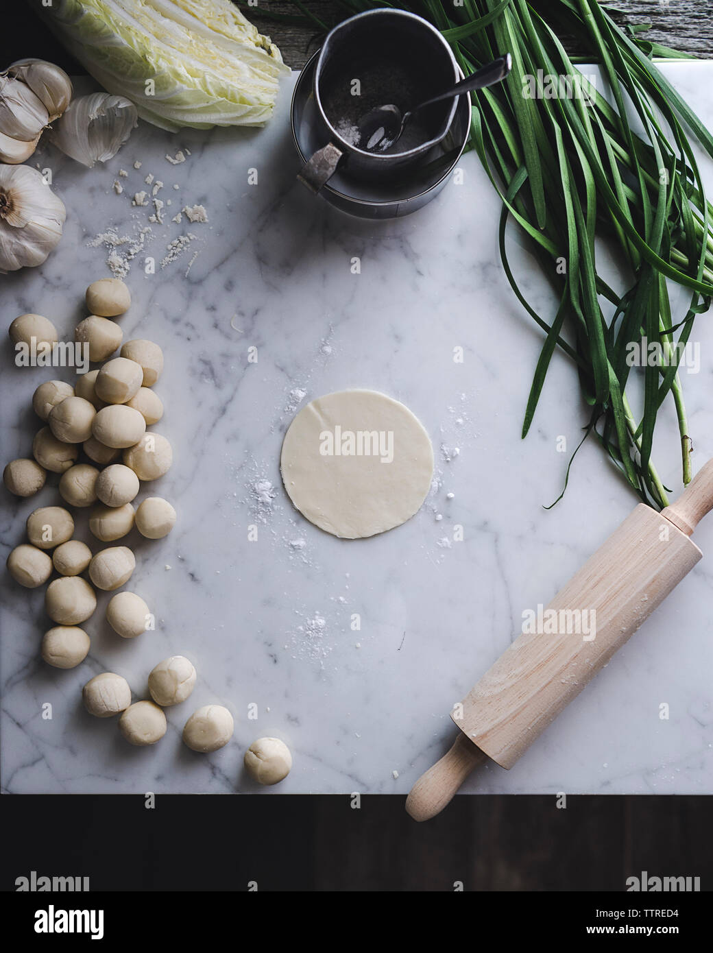 Overhead view of dough balls and vegetables on kitchen counter Stock ...