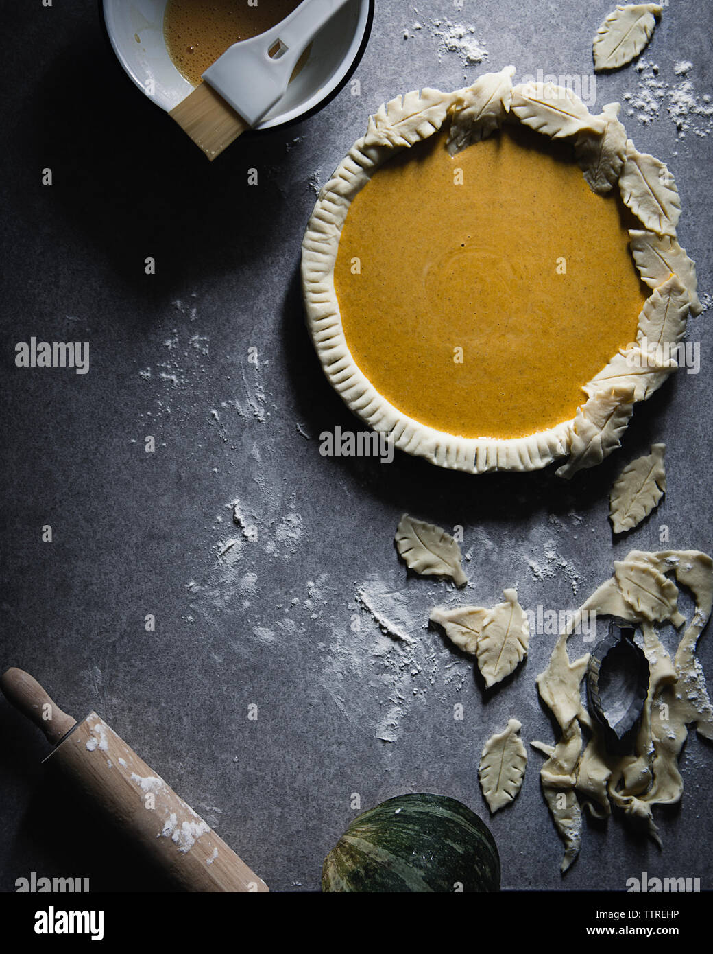 High angle view of pumpkin pie with dough on table Stock Photo - Alamy