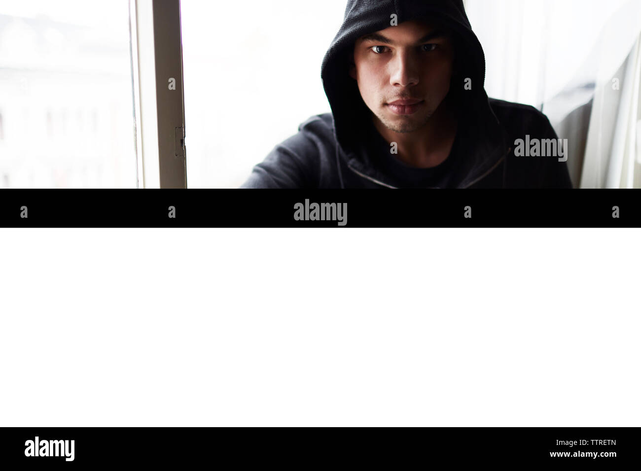 Black hooded man hi-res stock photography and images - Alamy