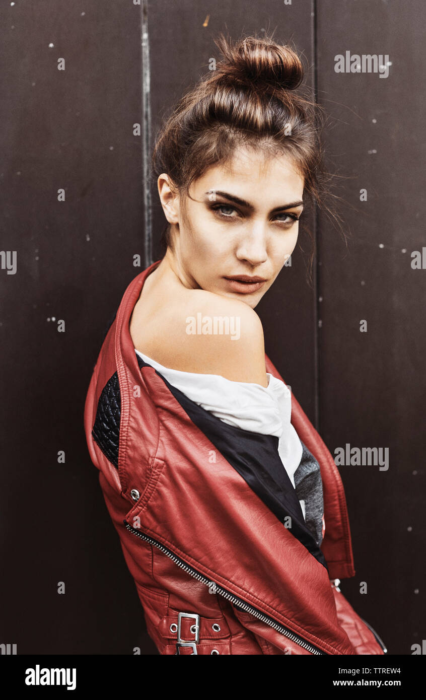 Side view portrait of seductive young woman wearing leather jacket ...