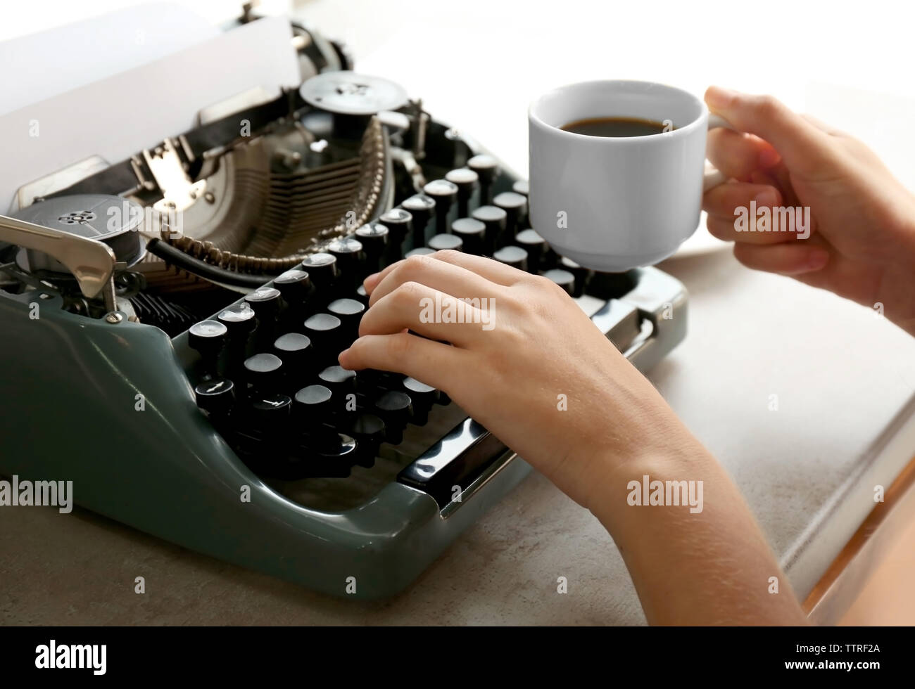 Woman holding retro typewriter hi-res stock photography and images - Alamy