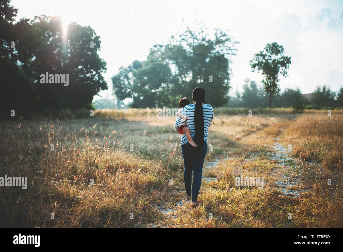 Indian woman carrying baby on hi-res stock photography and images - Alamy
