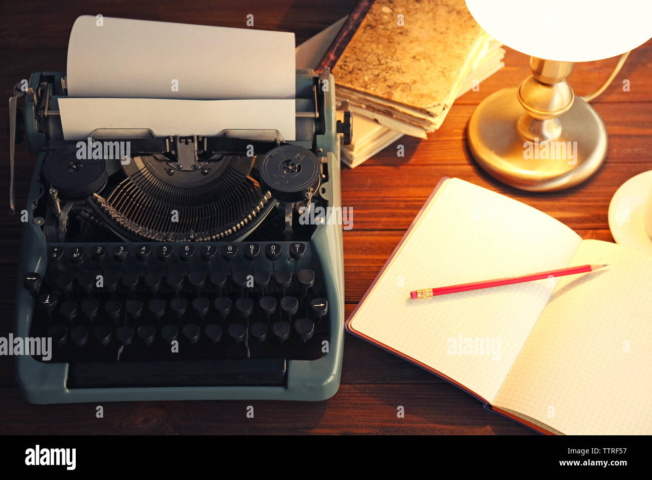 Old typewriter and notebook on the table, top view Stock Photo - Alamy