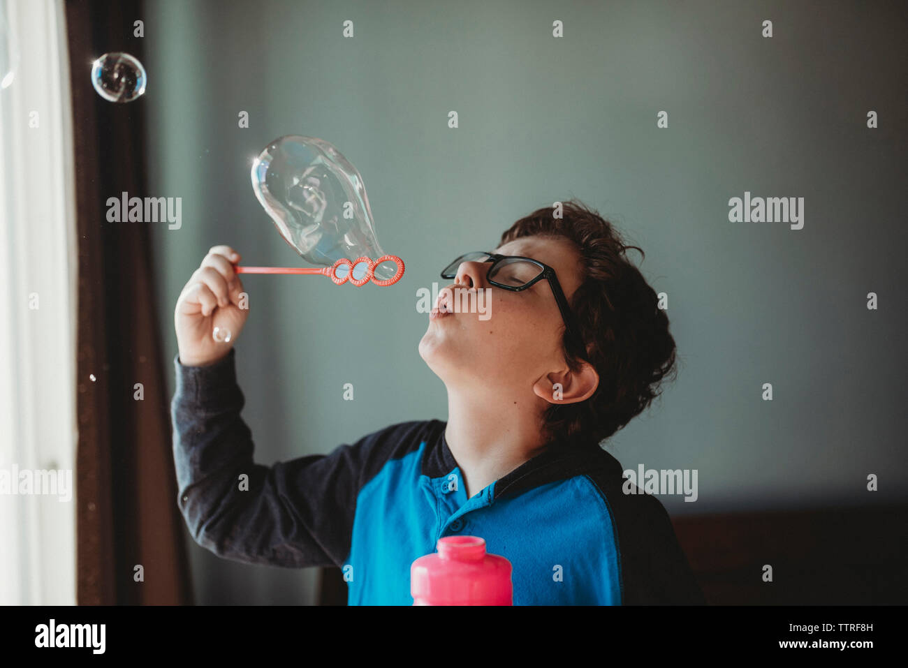 Boy with bubble wand hi-res stock photography and images - Alamy