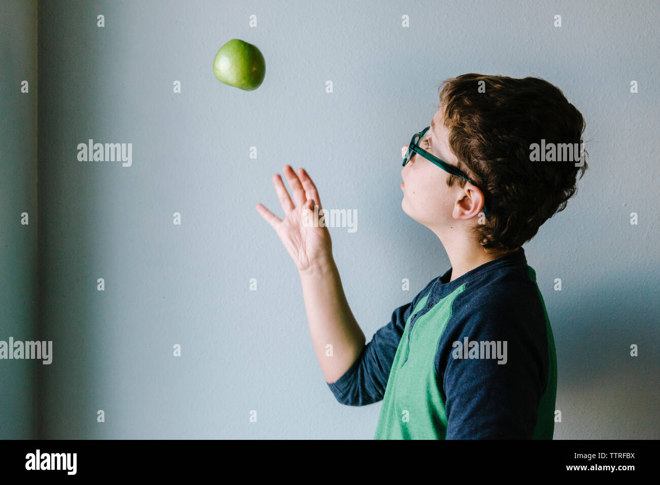 Boy throwing apple air hi-res stock photography and images - Alamy