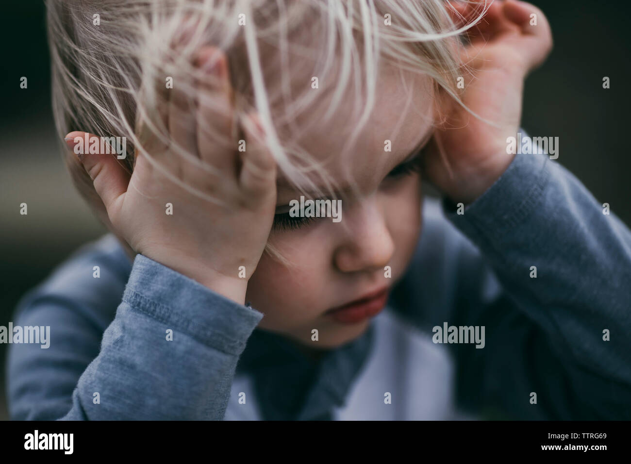 High angle view of cute boy with hands on head Stock Photo - Alamy