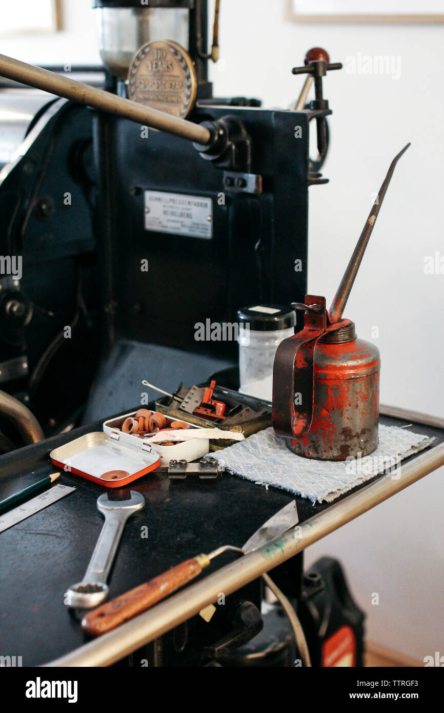 Equipment on table by screen printing press in workshop Stock Photo - Alamy