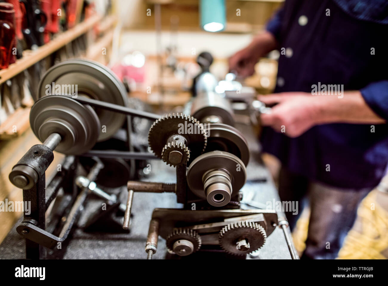 Midsection of worker operating machinery in workshop Stock Photo - Alamy