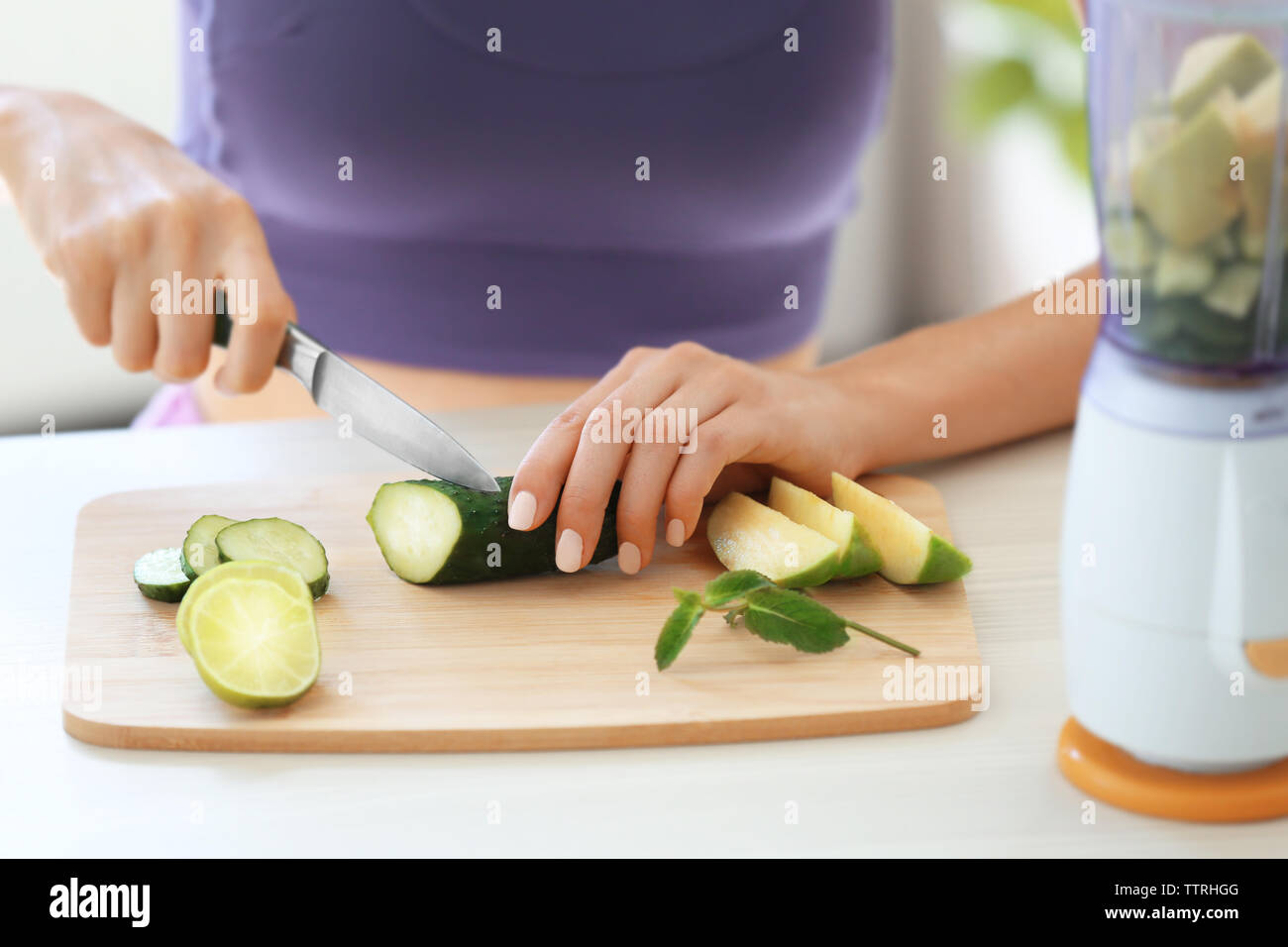 Girl cutting vegetables and fruits on kitchen Stock Photo - Alamy