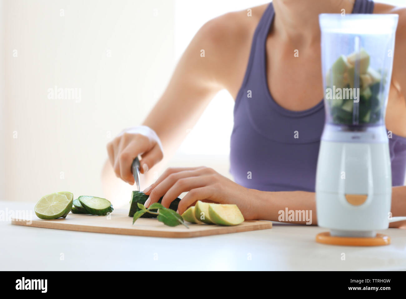Girl cutting vegetables and fruits on kitchen Stock Photo - Alamy