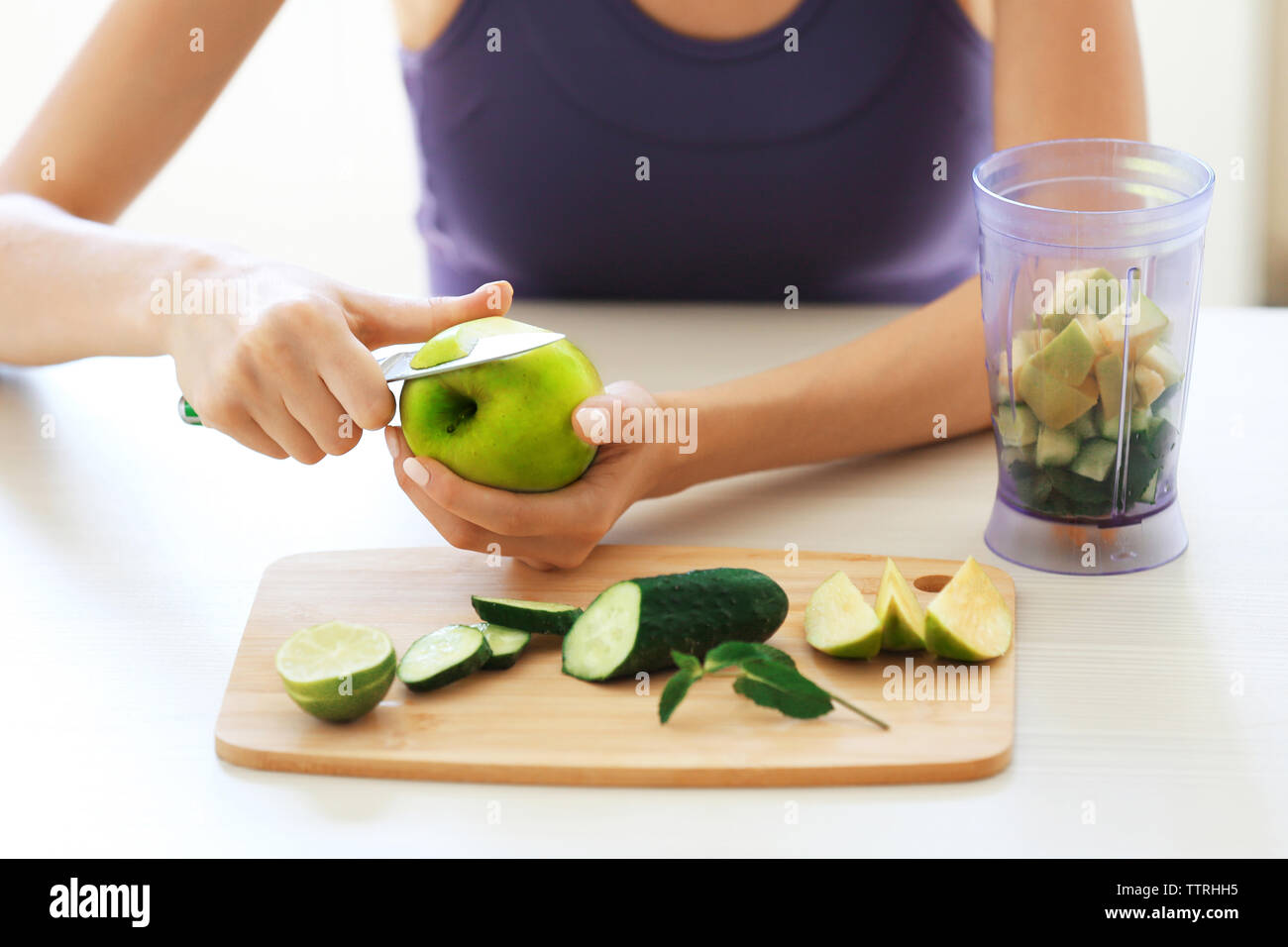 Girl cutting vegetables and fruits on kitchen Stock Photo - Alamy