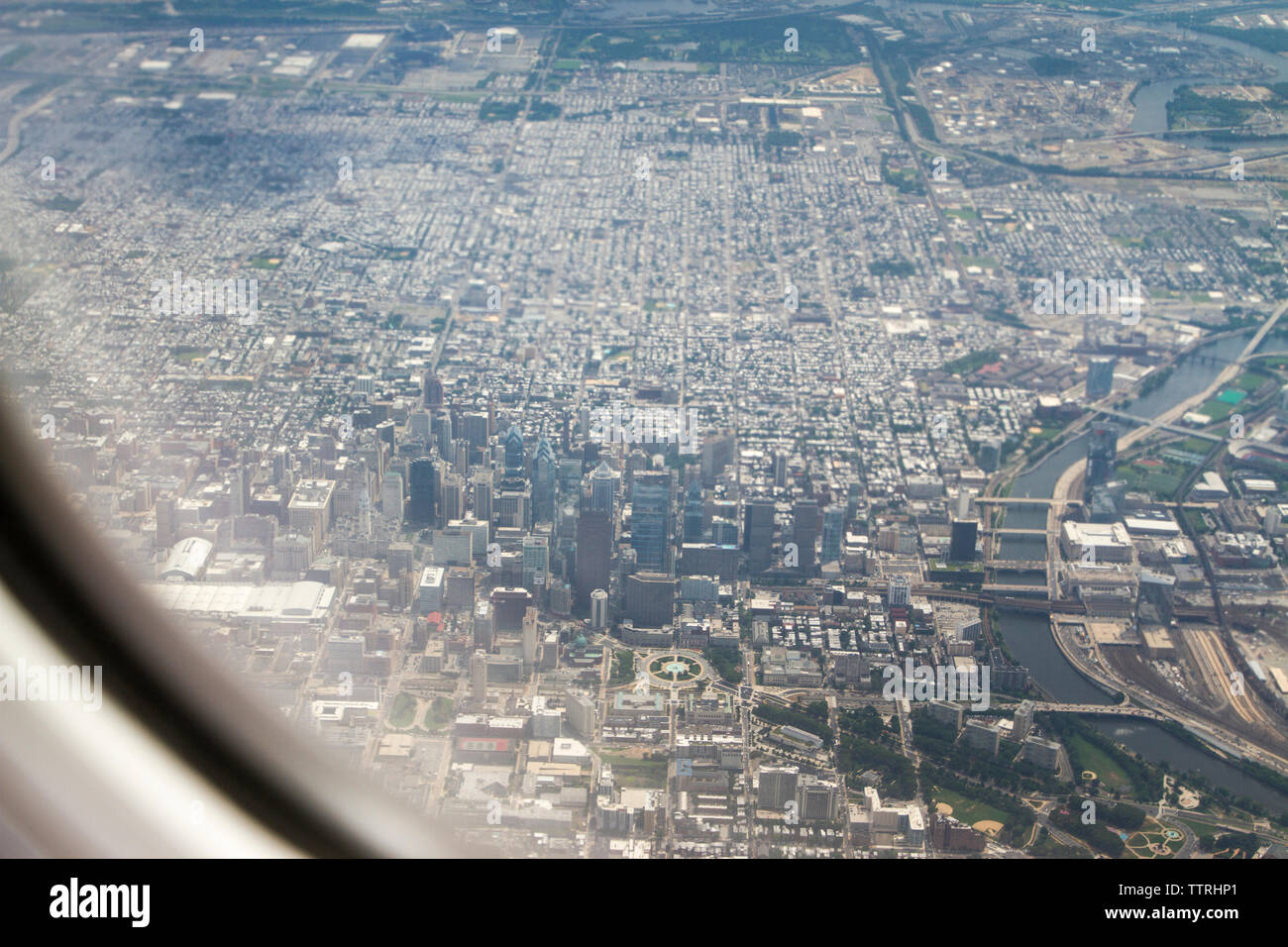 Aerial view of cityscape seen through airplane window Stock Photo - Alamy