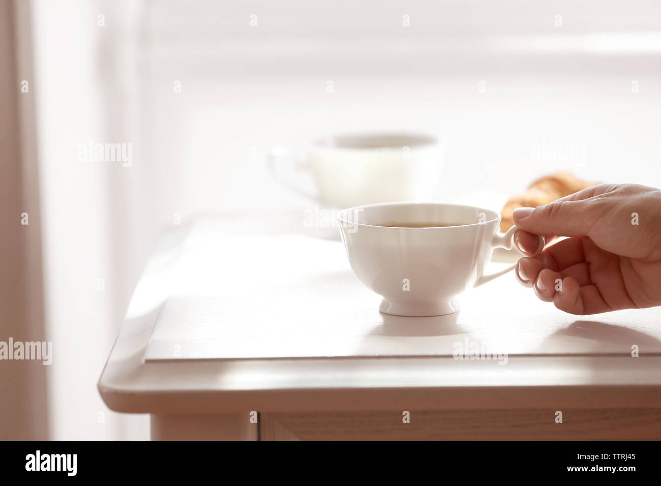 Female hand holding cup of tea hi-res stock photography and images - Alamy