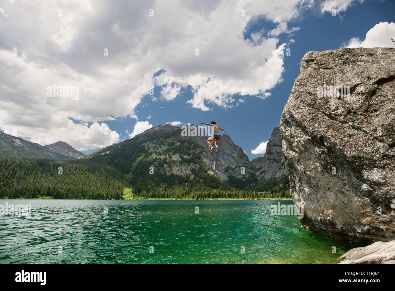 Boy jumping cliff hi-res stock photography and images - Alamy
