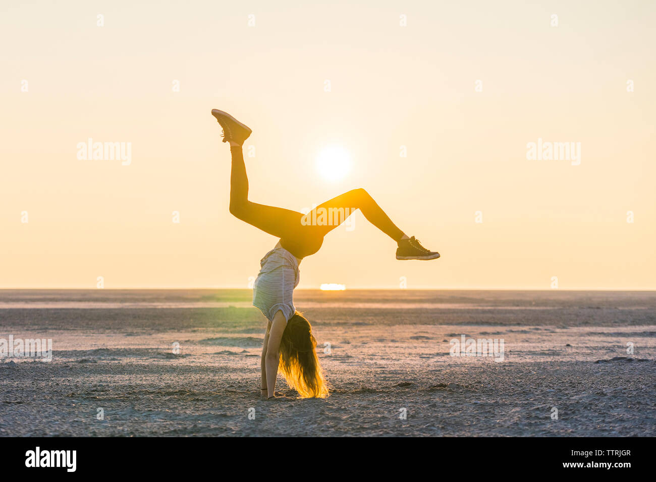 Woman doing handstand beach hi-res stock photography and images - Alamy