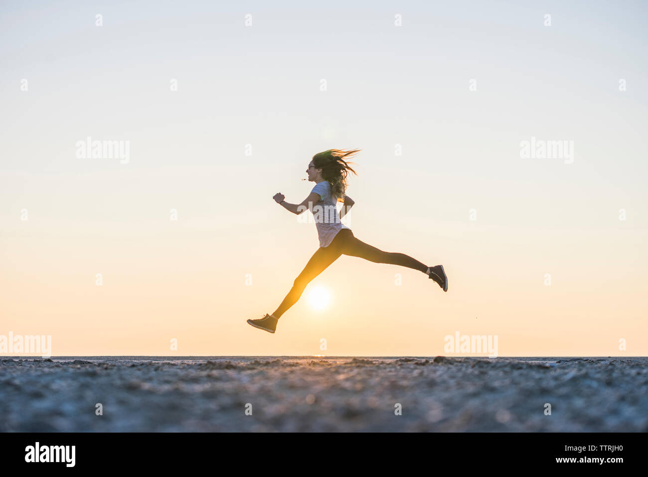 Person jumping into water sunset hi-res stock photography and images ...